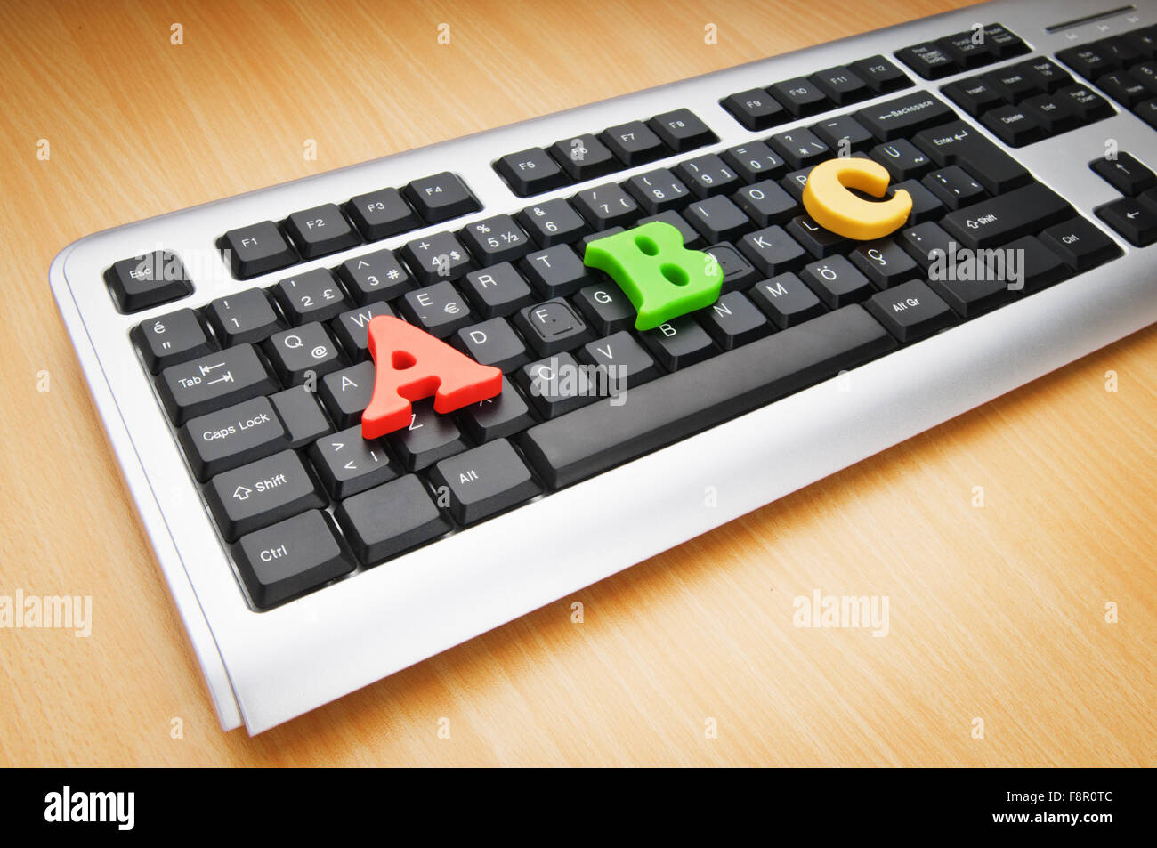 Early education concept with keyboard and letters Stock Photo - Alamy