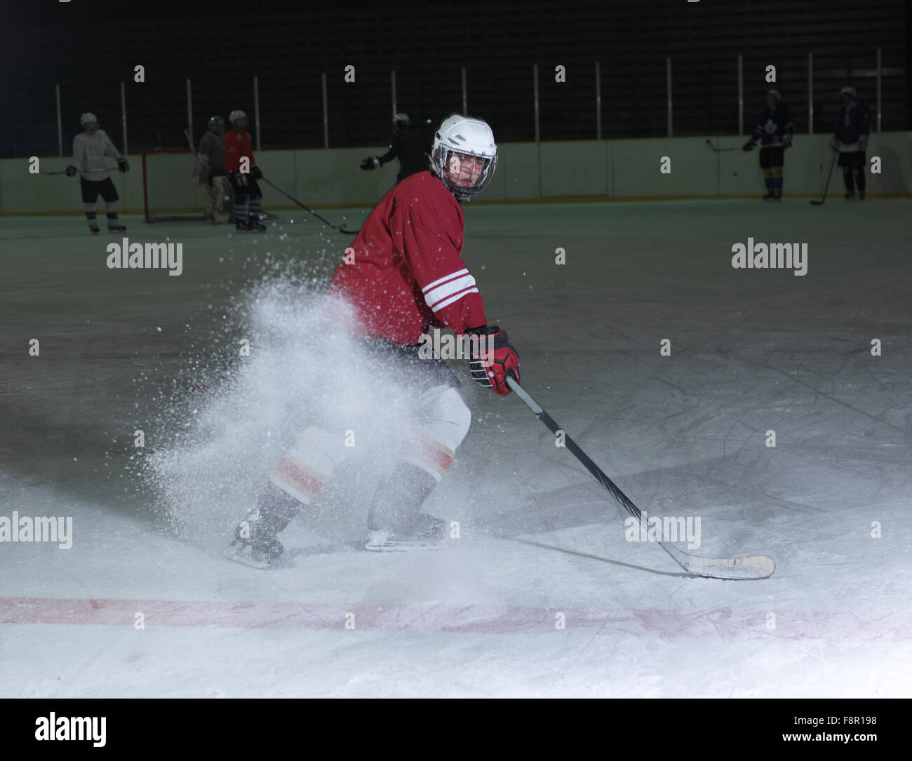 ice hockey player in action kicking with stick Stock Photo - Alamy