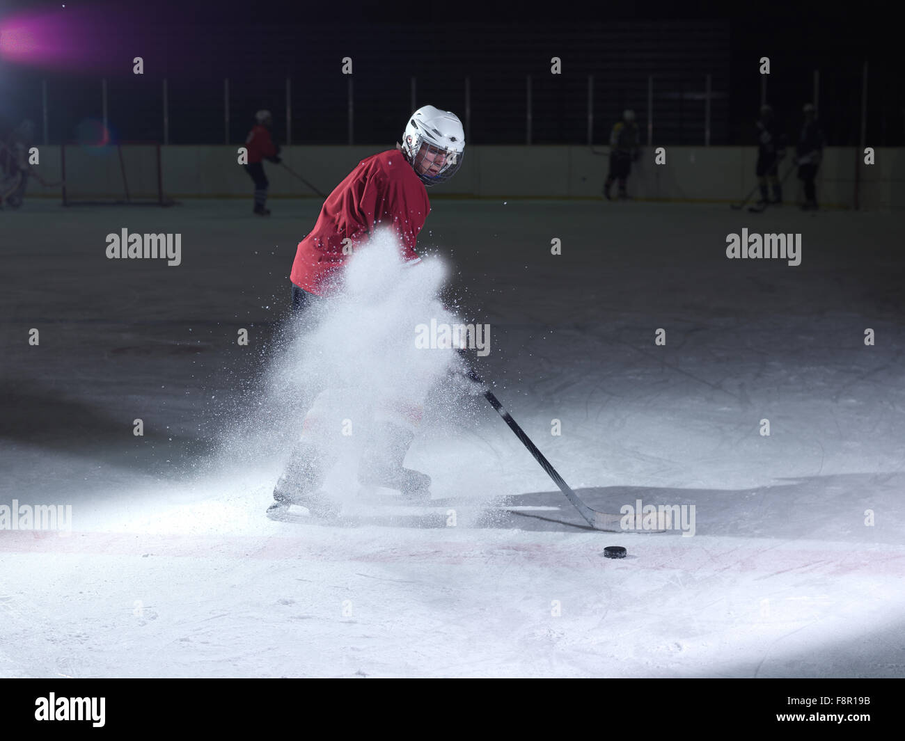 ice hockey player in action kicking with stick Stock Photo - Alamy