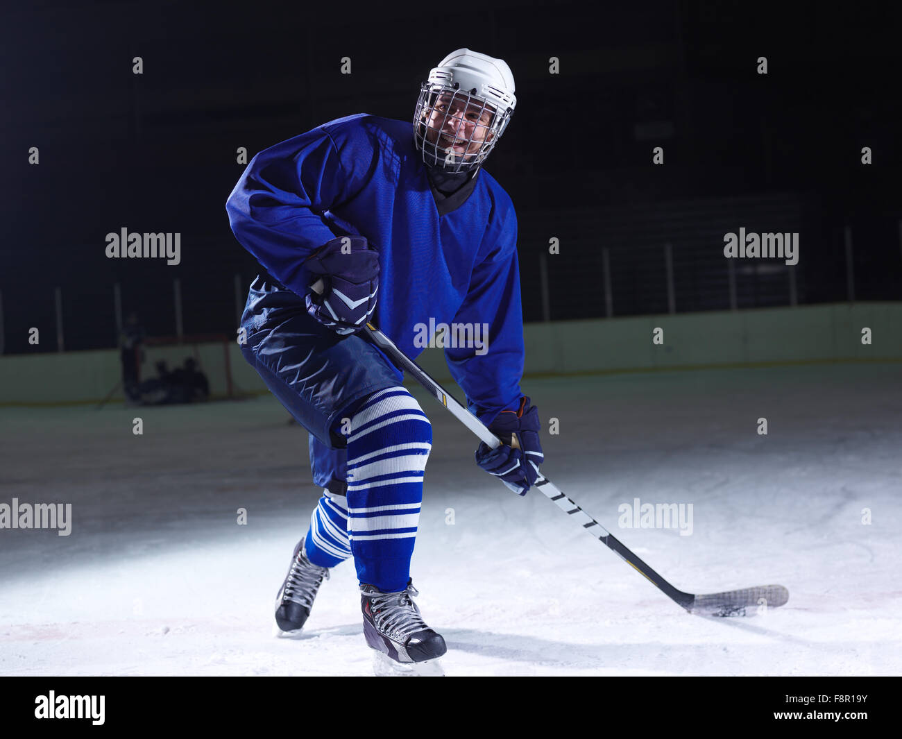 ice hockey player in action kicking with stick Stock Photo - Alamy