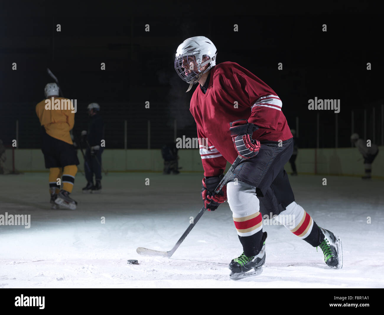 ice hockey player in action kicking with stick Stock Photo - Alamy