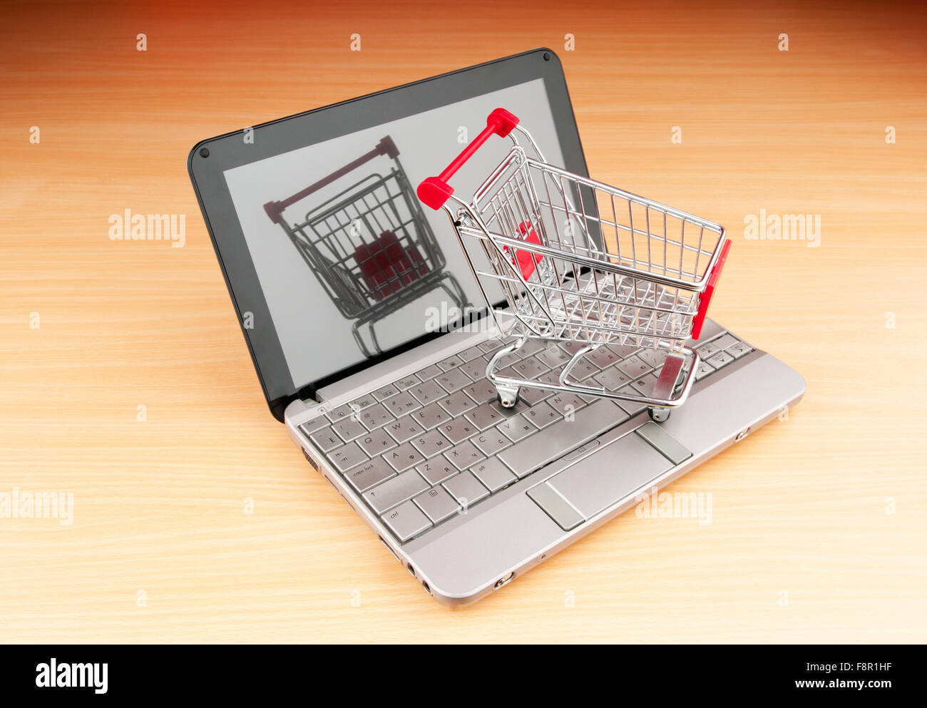 Internet online shopping concept with computer and cart Stock Photo - Alamy