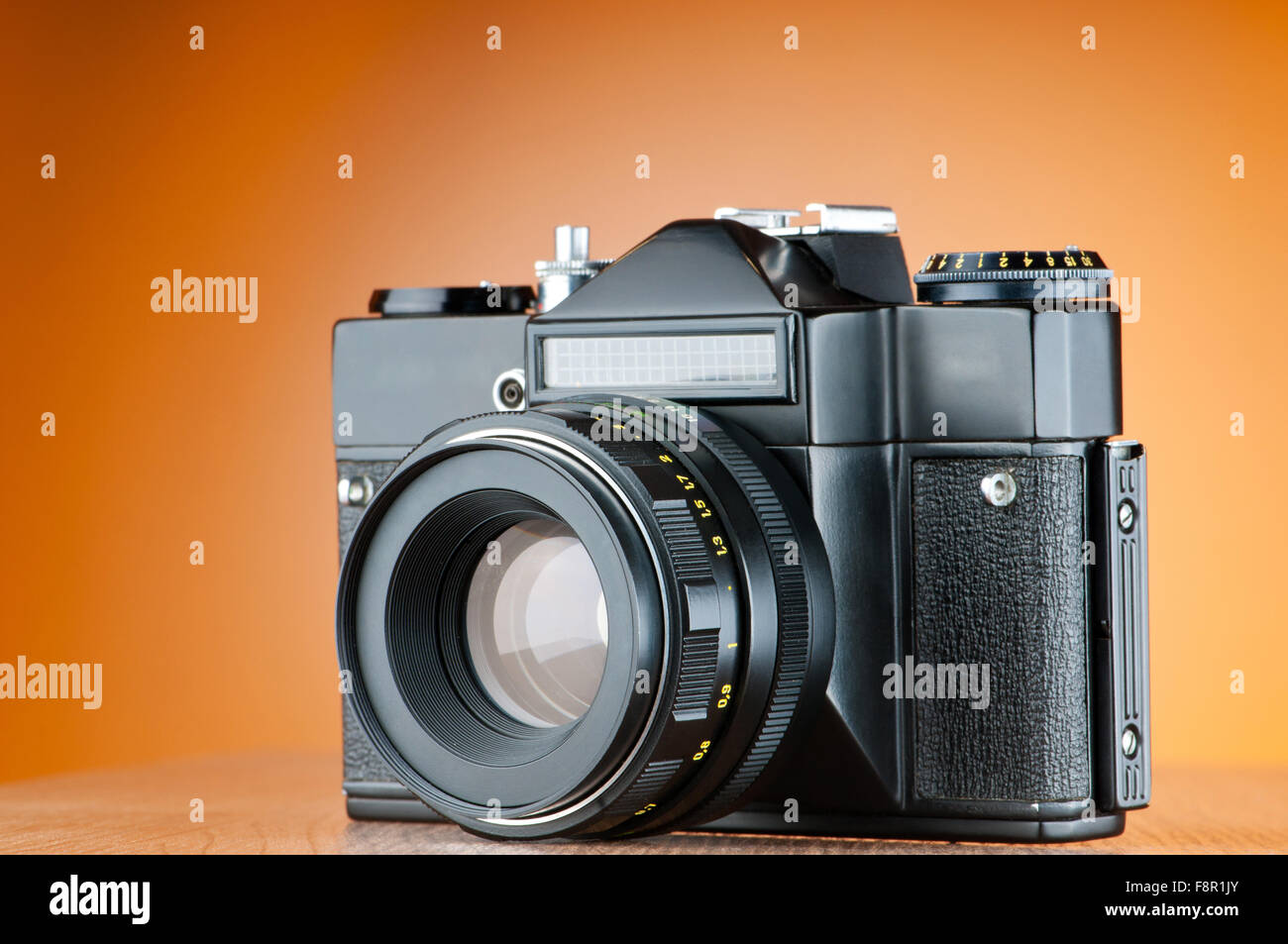 Vintage film camera against gradient background Stock Photo - Alamy