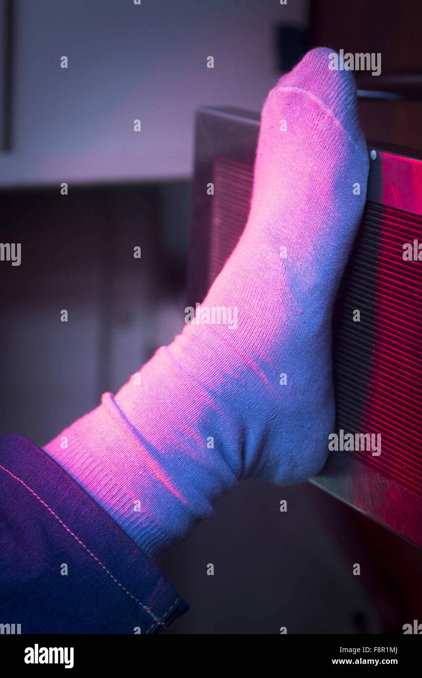 Patient foot in red physiotherapy heat treatment under hot light Stock ...