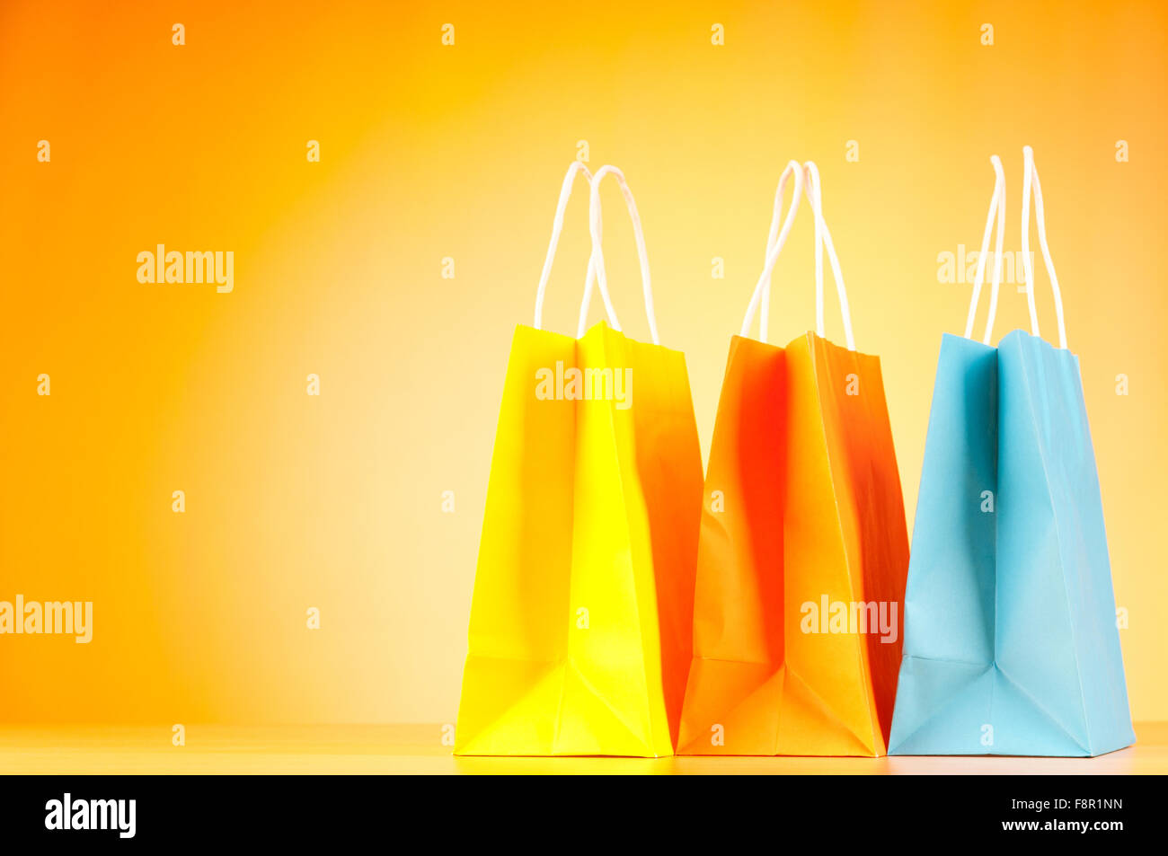 Colourful paper shopping bags against gradient background Stock Photo ...