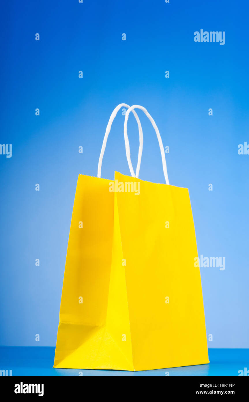 Colourful paper shopping bags against gradient background Stock Photo ...