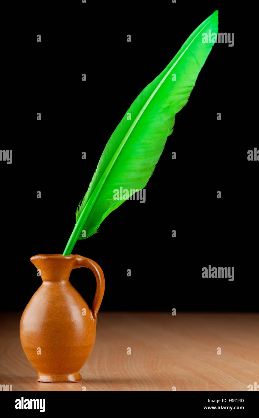 Writing feather against gradient background Stock Photo - Alamy