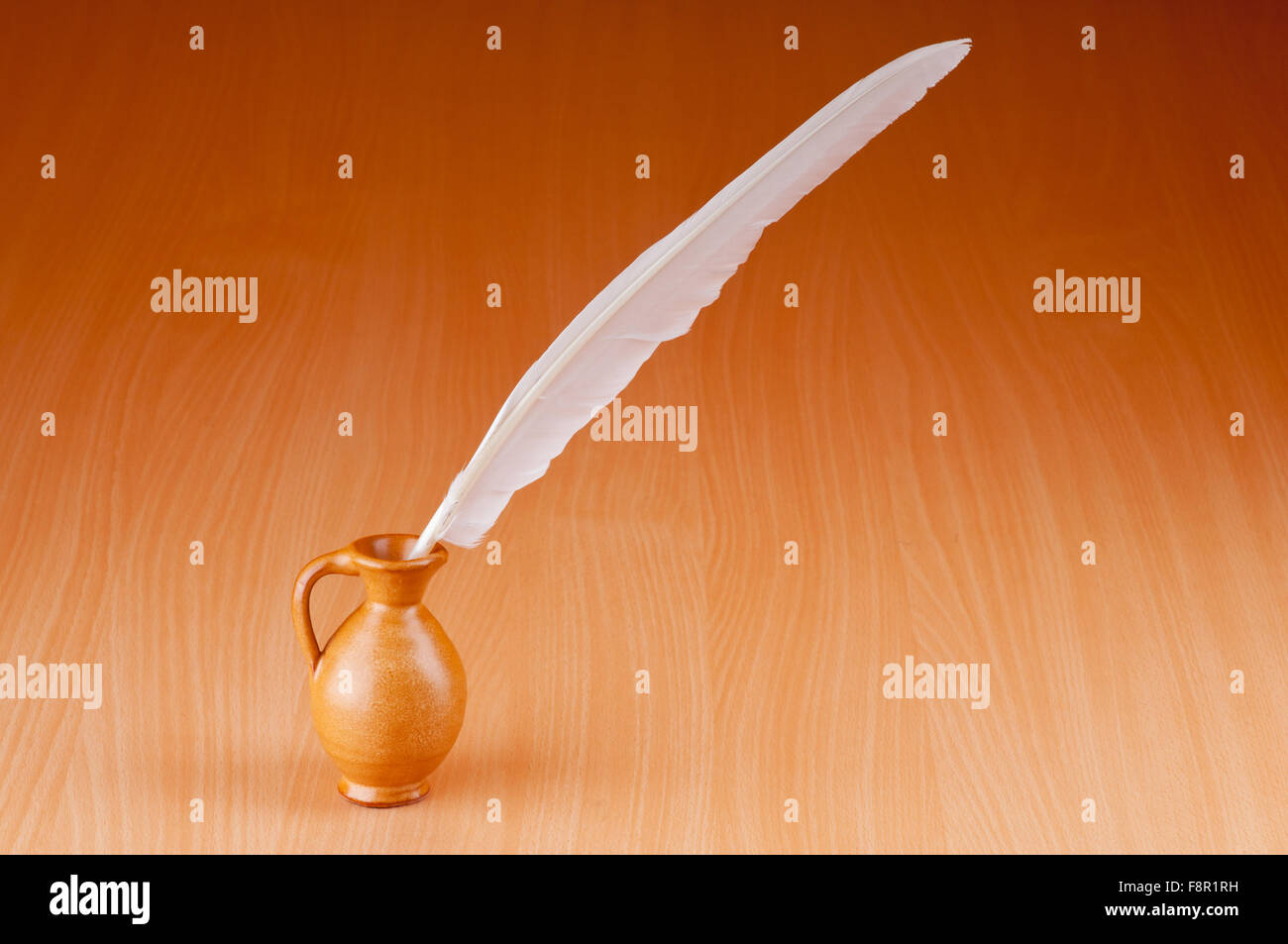 Writing feather against gradient background Stock Photo - Alamy