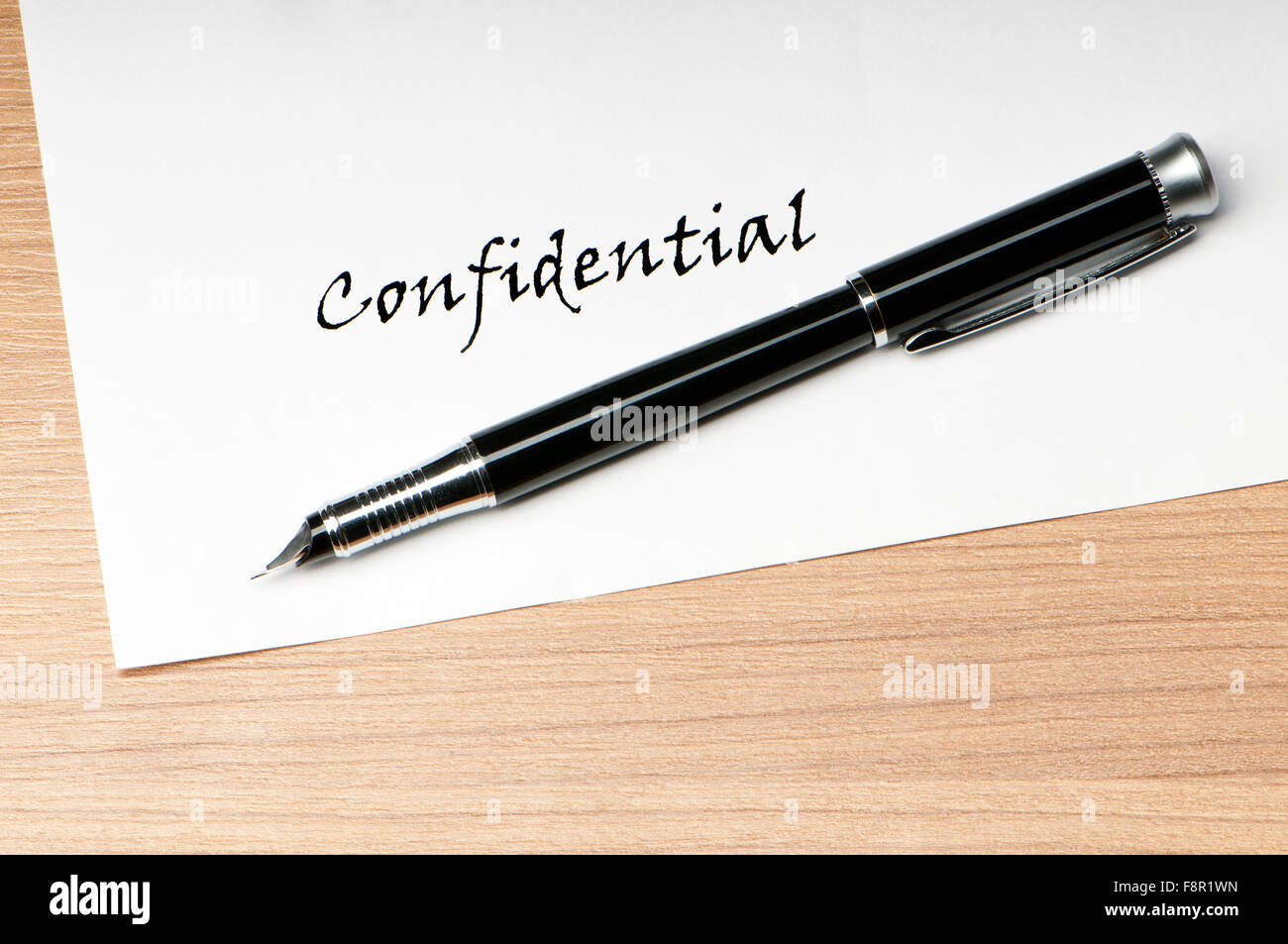Pen and confidential message on white Stock Photo - Alamy