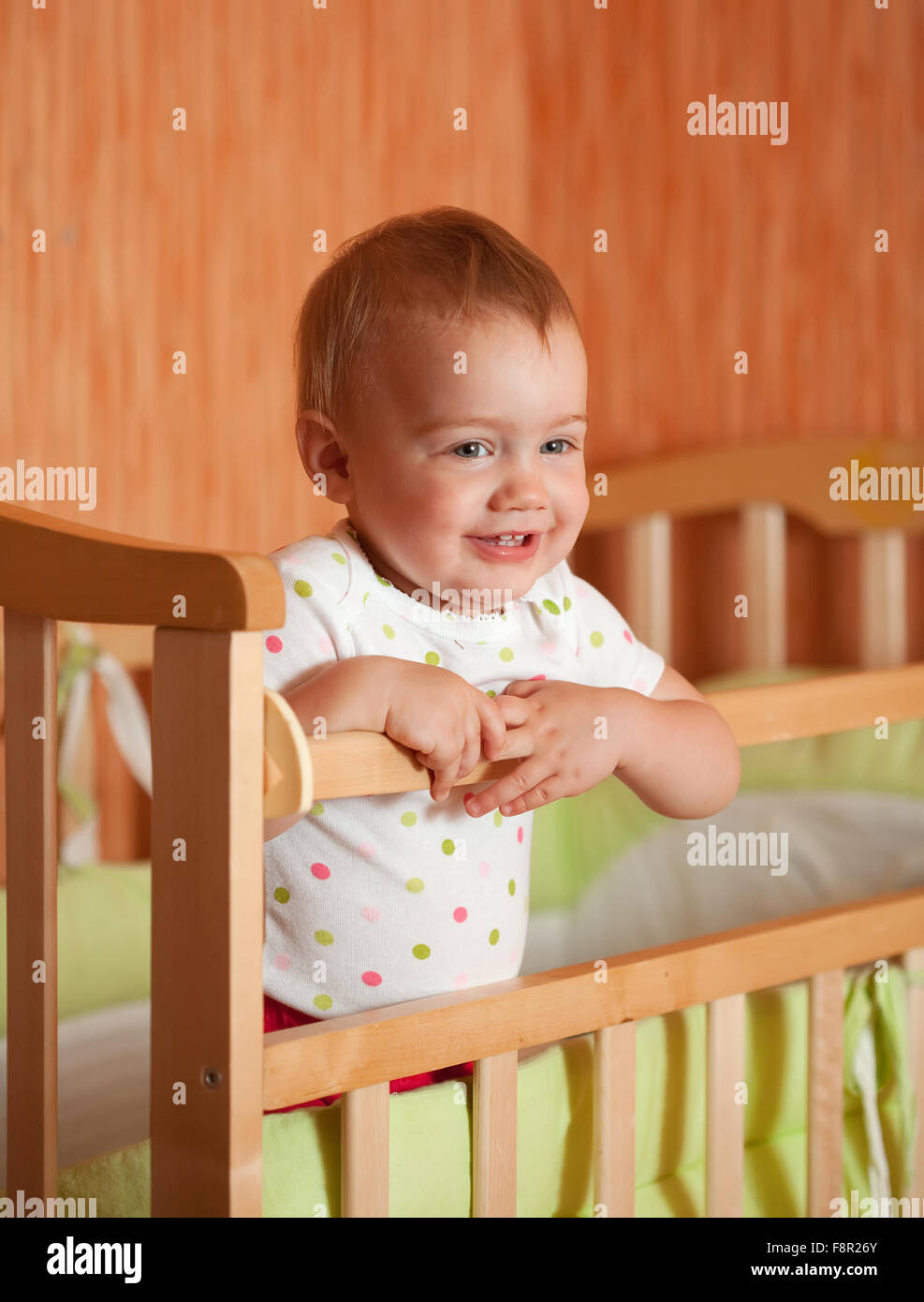 Happy baby in the crib Stock Photo - Alamy