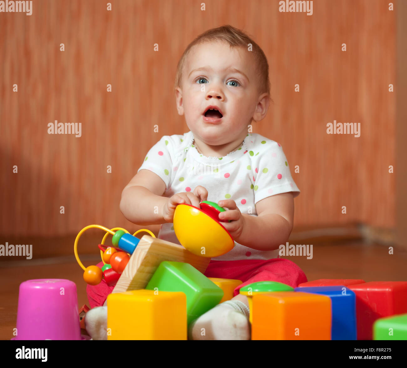Year-old child with toys on the floor Stock Photo - Alamy