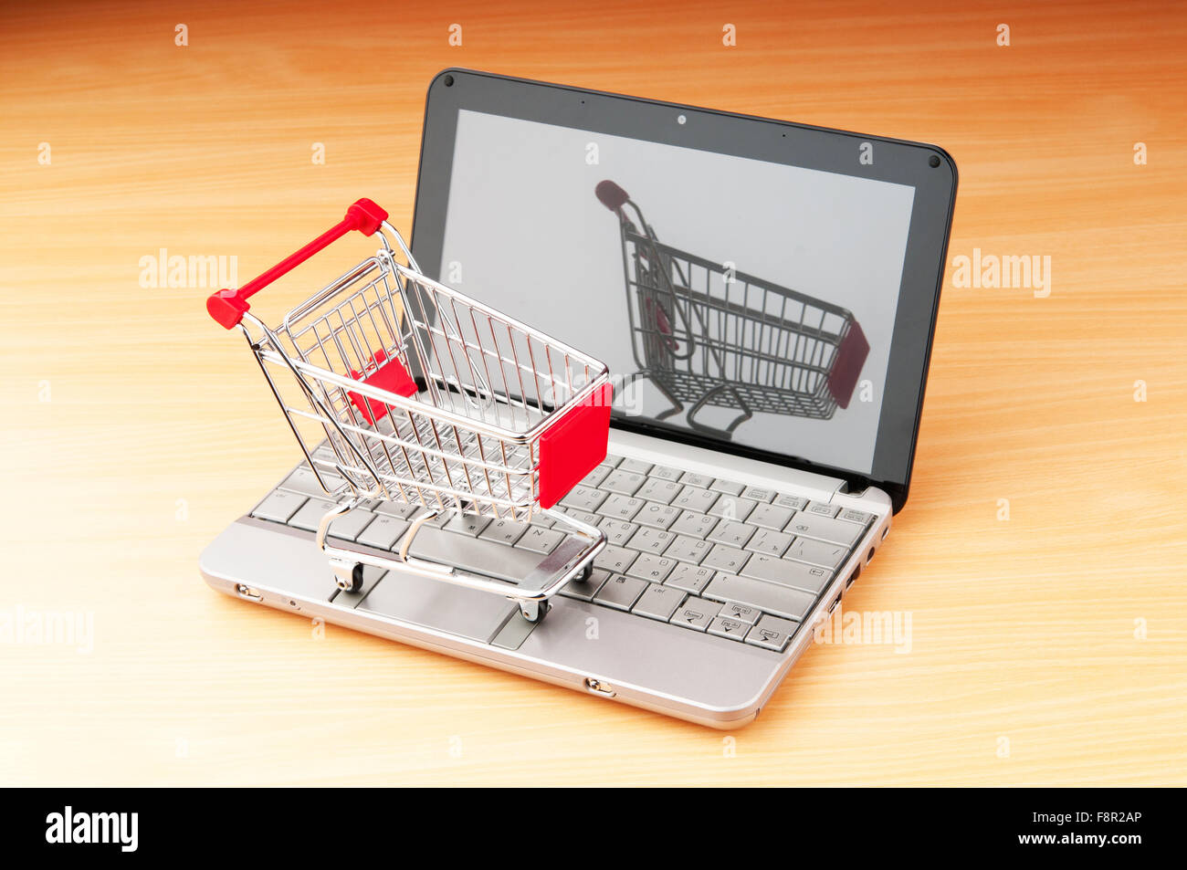 Internet online shopping concept with computer and cart Stock Photo - Alamy