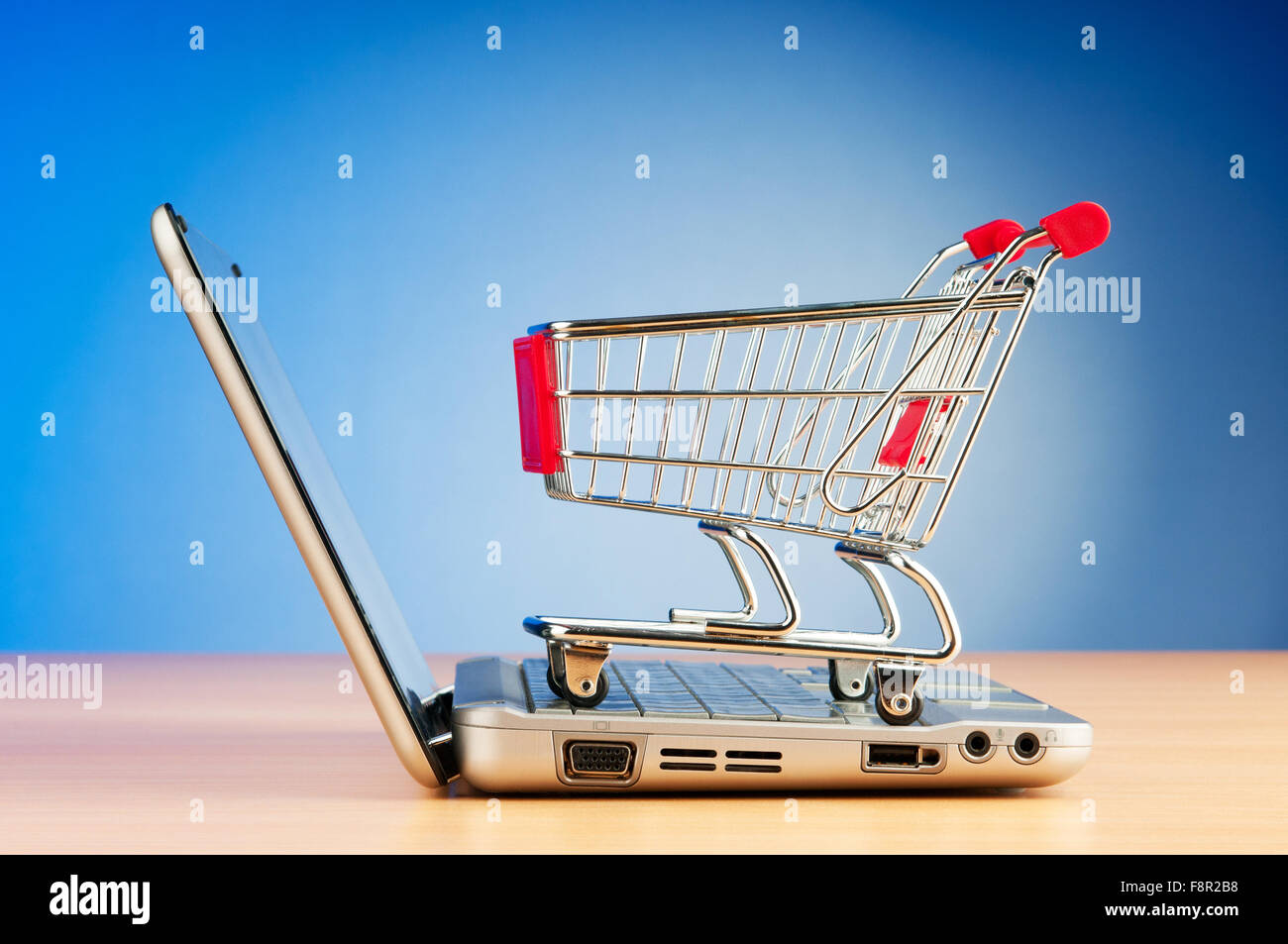 Internet online shopping concept with computer and cart Stock Photo - Alamy