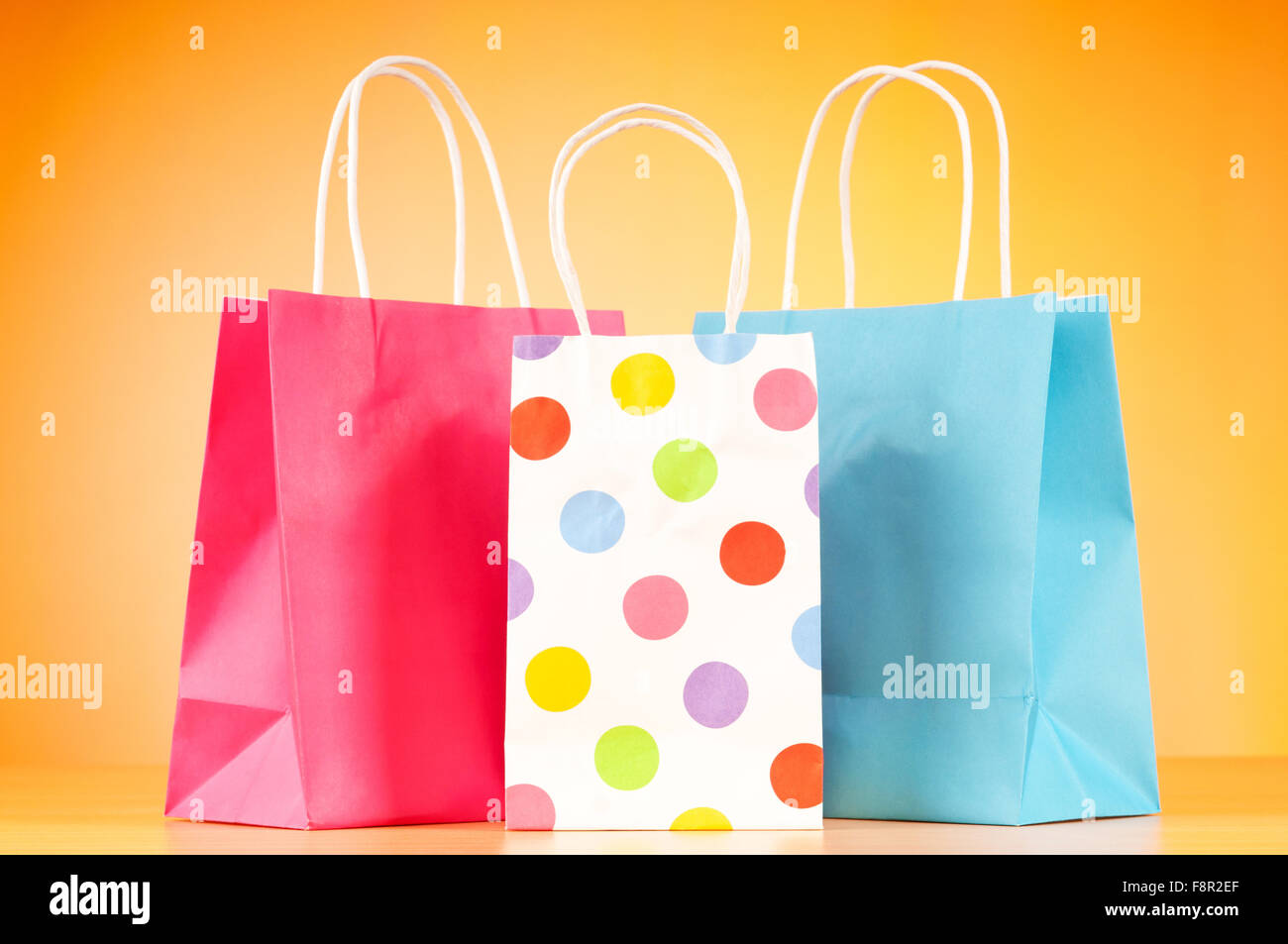 Colourful paper shopping bags against gradient background Stock Photo ...