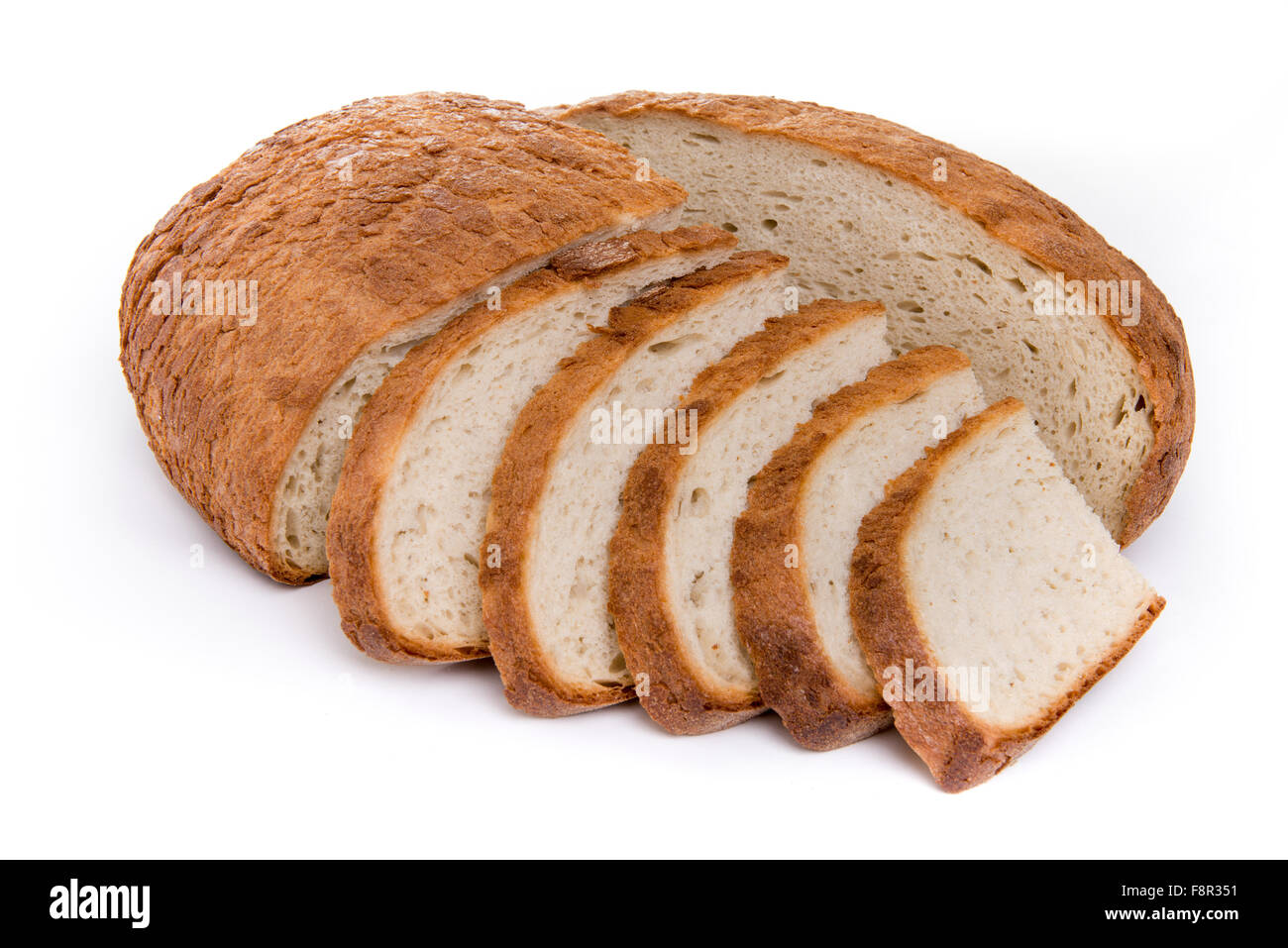 close-up of a loaf of white bread cut in two and in five slices, on a ...
