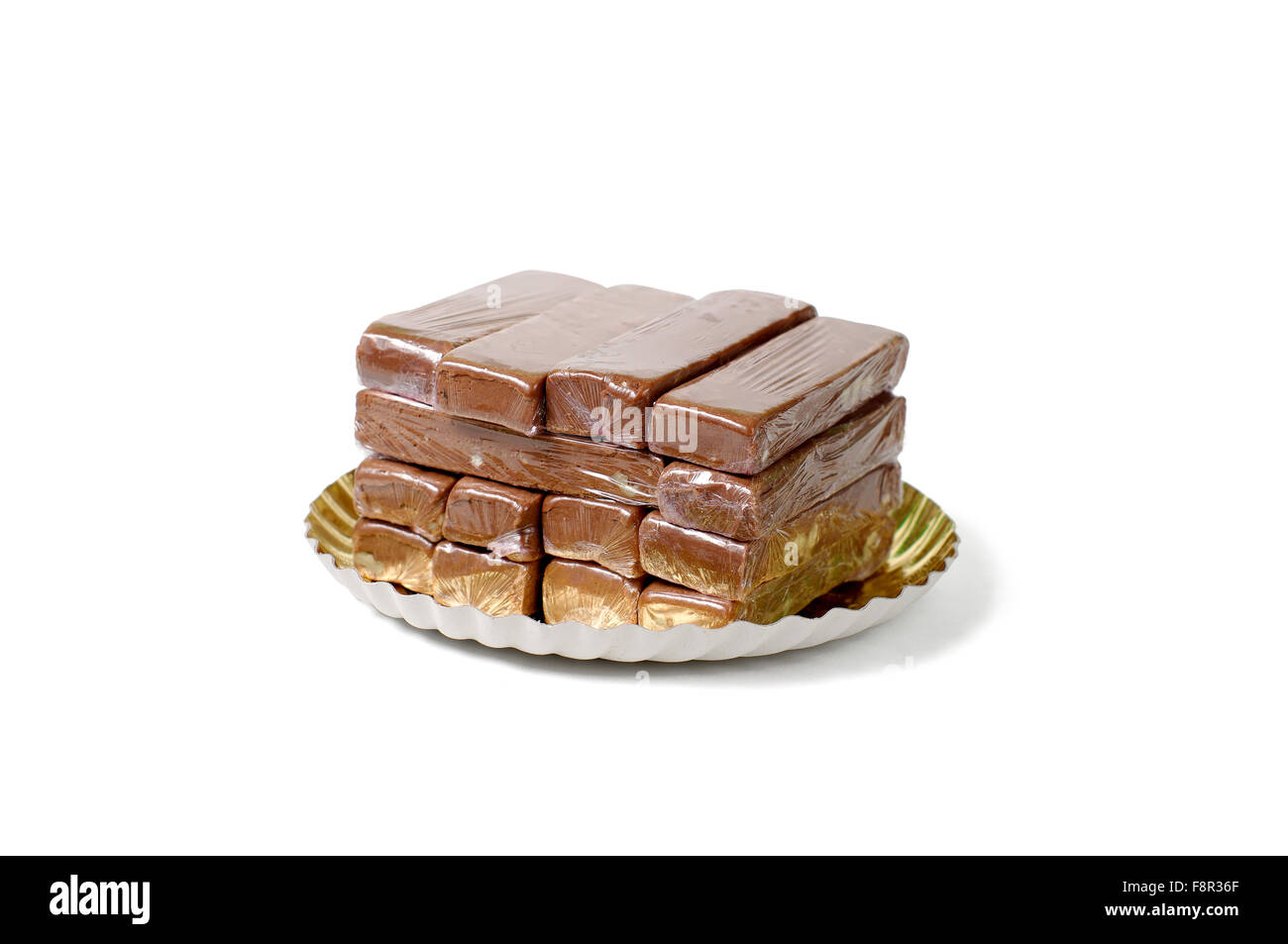 close-up of a stack of fudge, wrapped individually in cellophane, on a ...