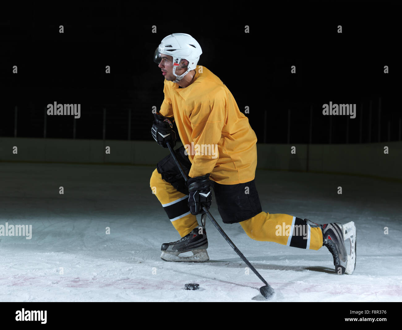ice hockey player in action kicking with stick Stock Photo - Alamy