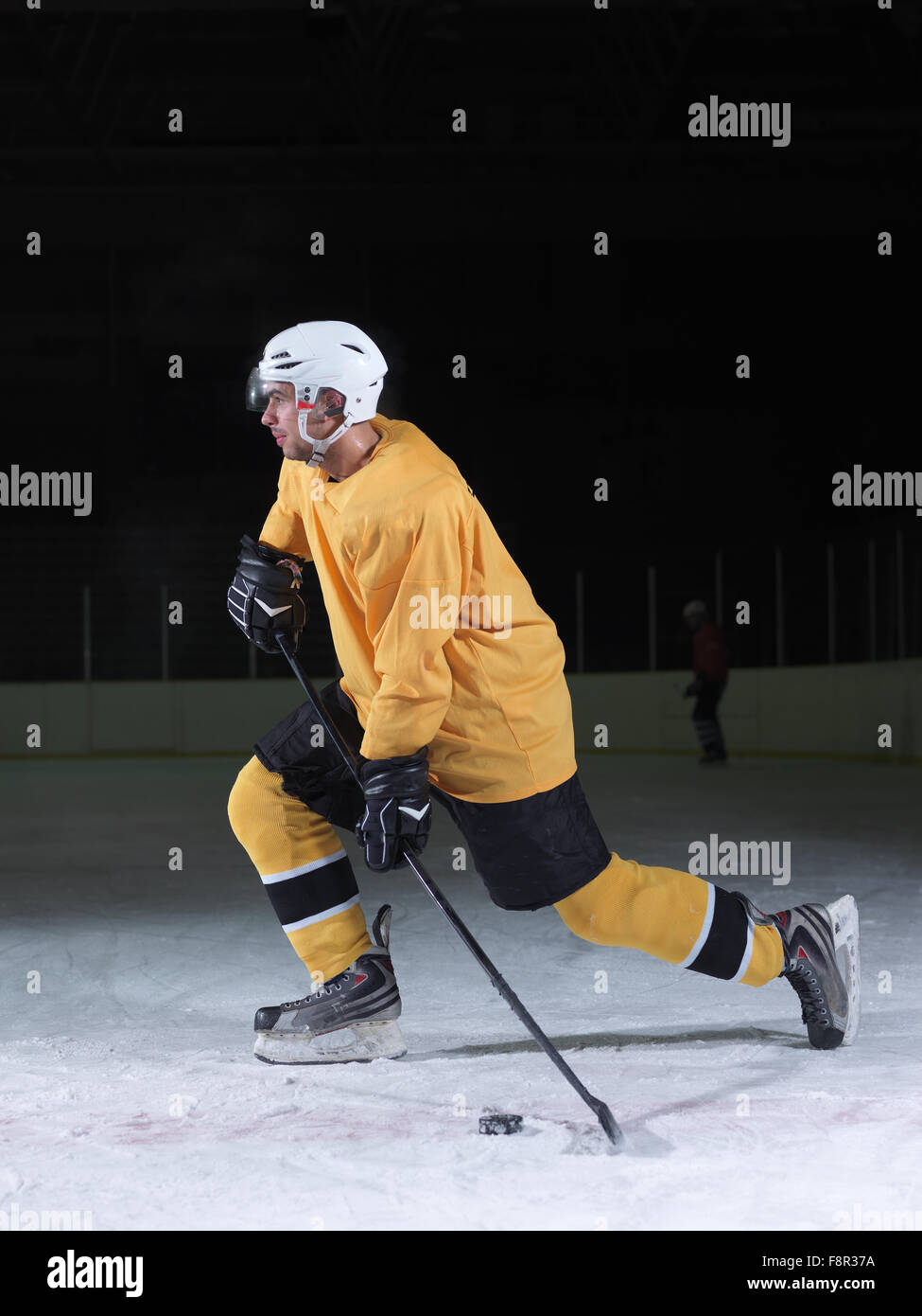 ice hockey player in action kicking with stick Stock Photo - Alamy
