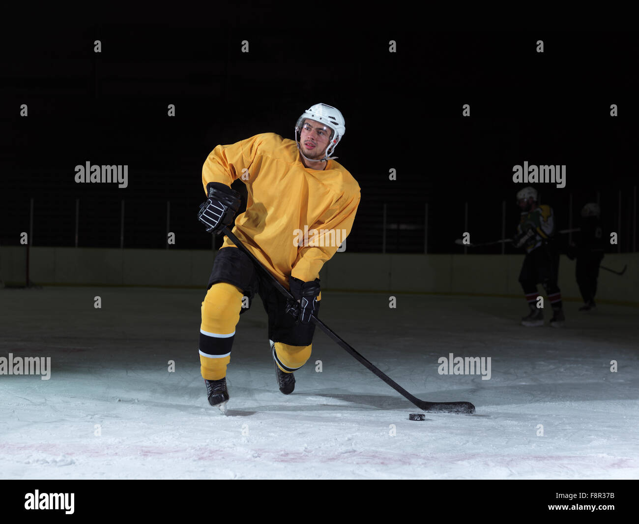 ice hockey player in action kicking with stick Stock Photo - Alamy