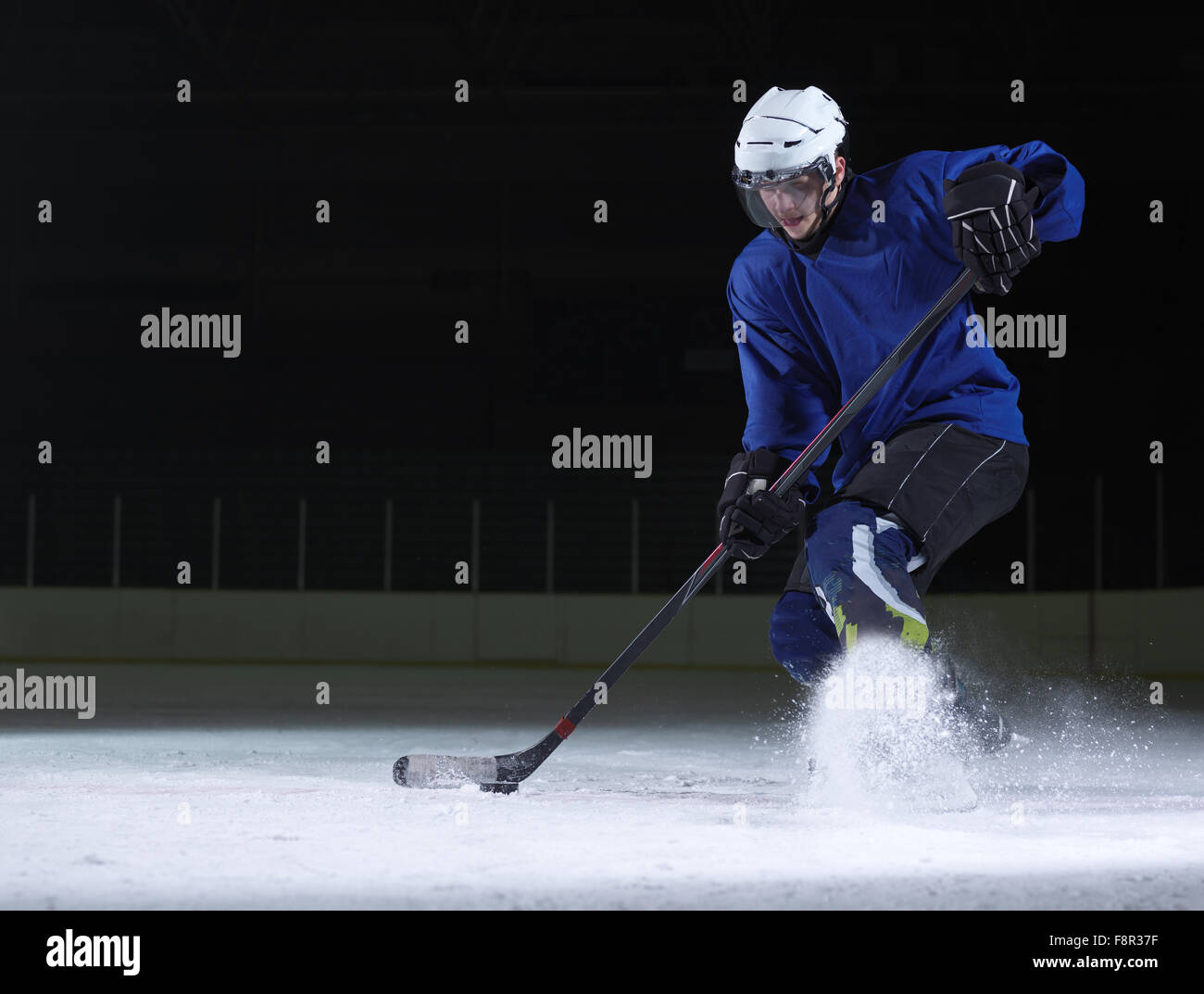 ice hockey player in action kicking with stick Stock Photo - Alamy