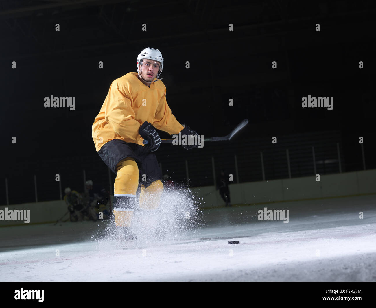 ice hockey player in action kicking with stick Stock Photo - Alamy