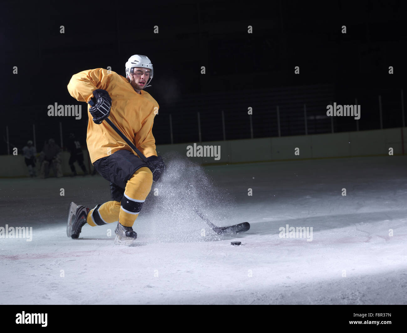 ice hockey player in action kicking with stick Stock Photo - Alamy