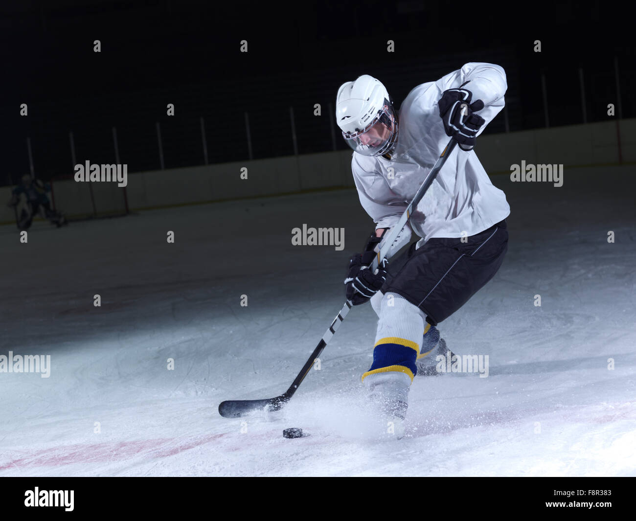 ice hockey player in action kicking with stick Stock Photo - Alamy