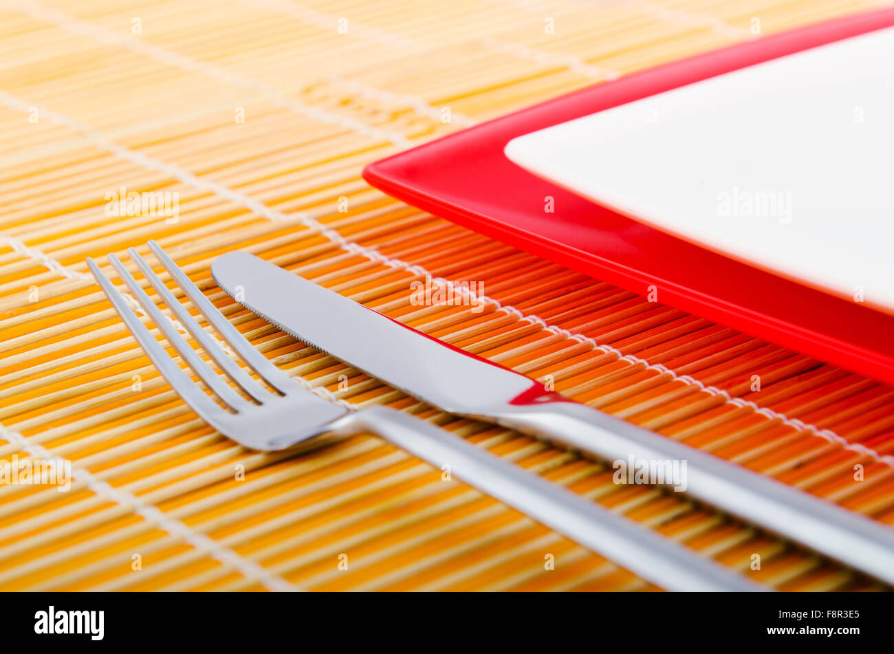 Empty plate with utensils Stock Photo - Alamy