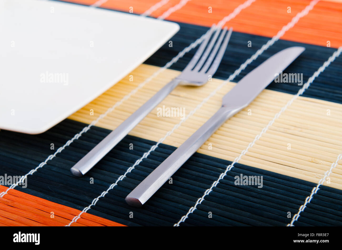Empty plate with utensils Stock Photo - Alamy