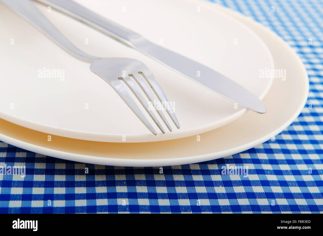 Empty plate with utensils Stock Photo - Alamy