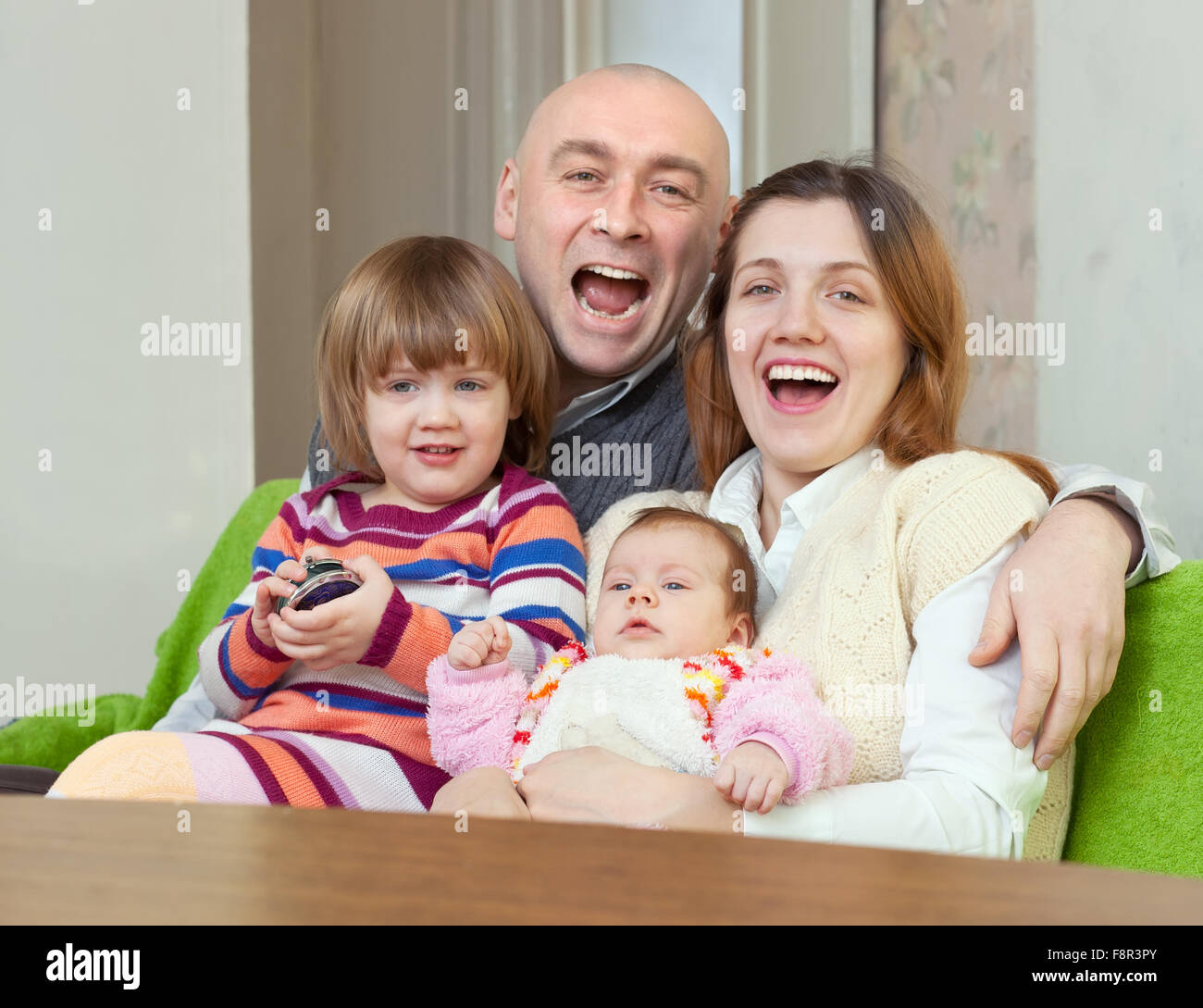 Happy couple together with children at home Stock Photo - Alamy