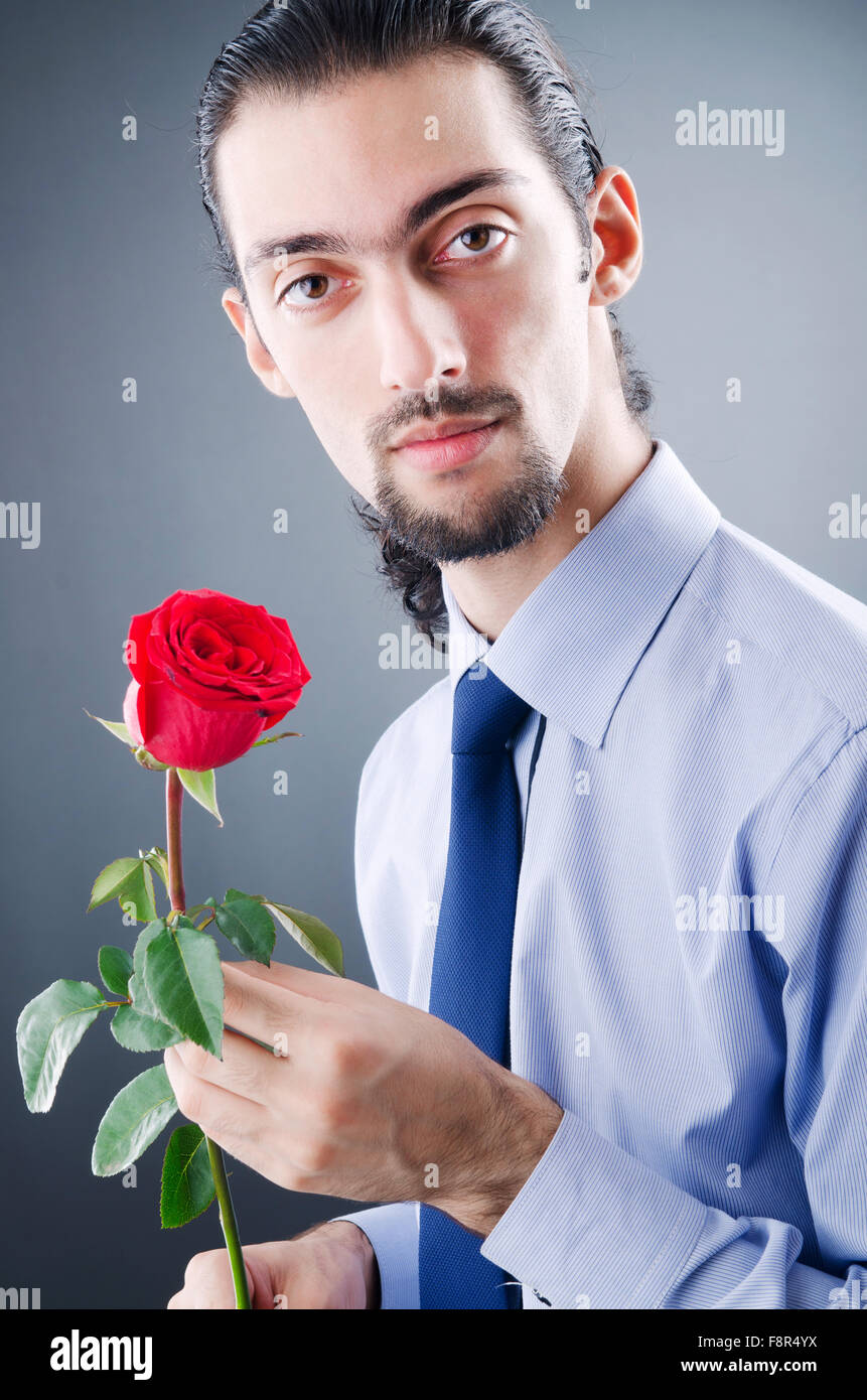 Young man with red rose Stock Photo - Alamy