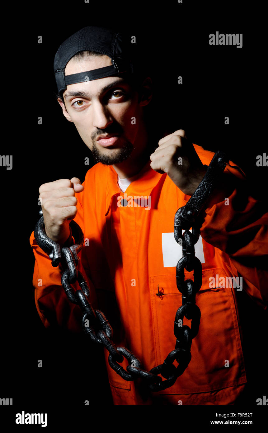 Inmate chained on black background Stock Photo - Alamy