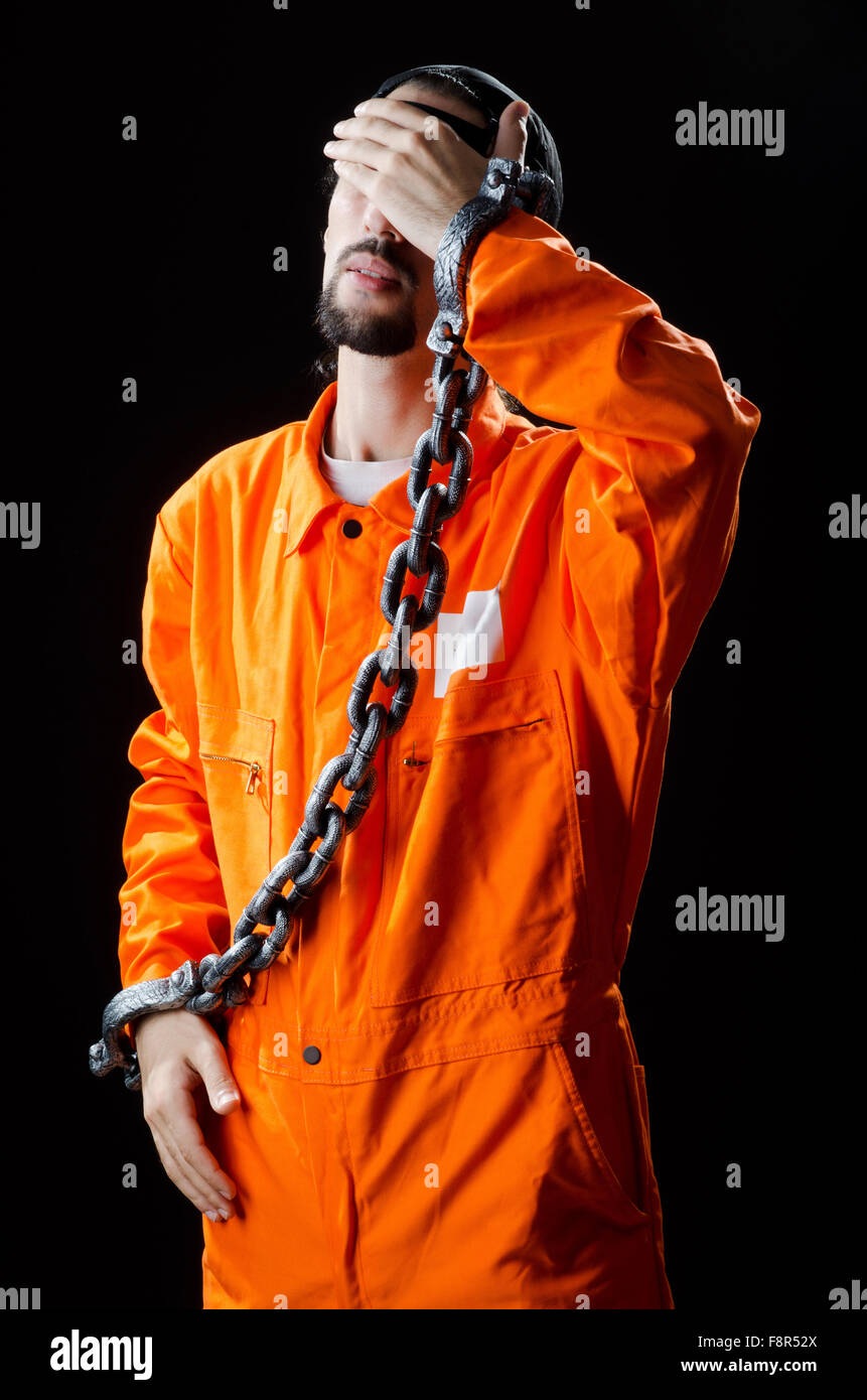 Inmate chained on black background Stock Photo - Alamy