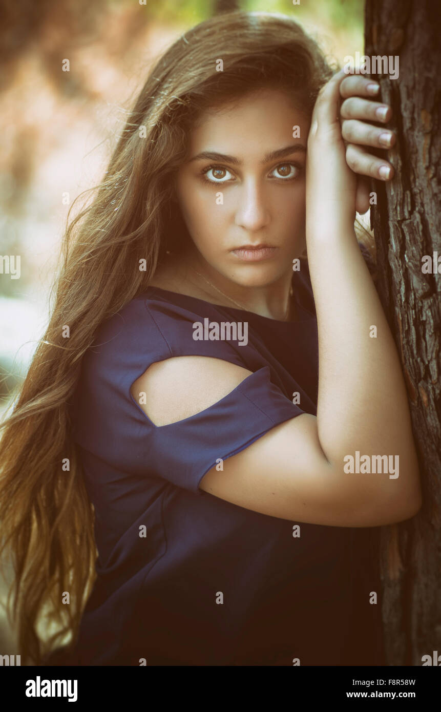 Sad teenage girl leaning tree hi-res stock photography and images - Alamy