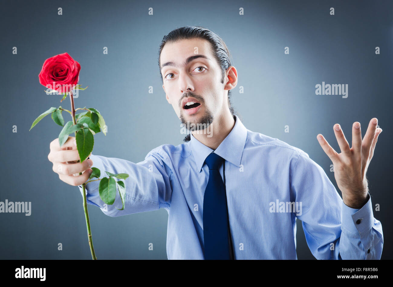 Young man with red rose Stock Photo - Alamy