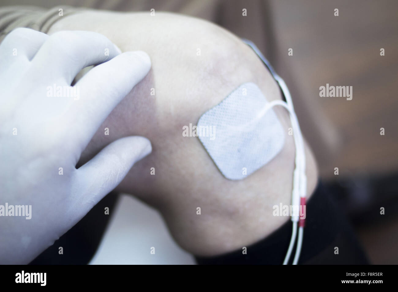 Patient leg and knee in electro physiotherapy electrical impulse ...