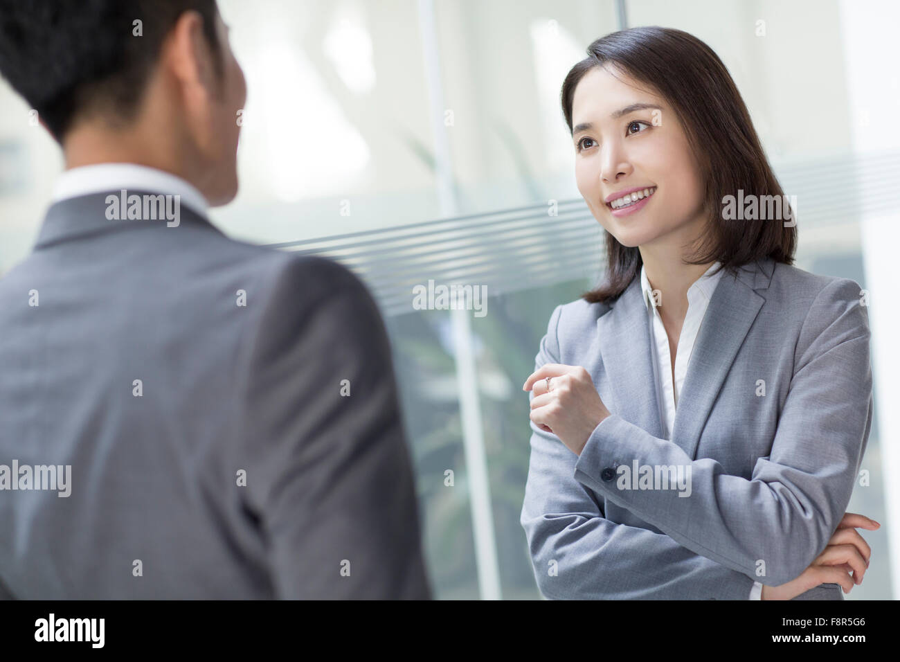 Business person talking in office Stock Photo - Alamy