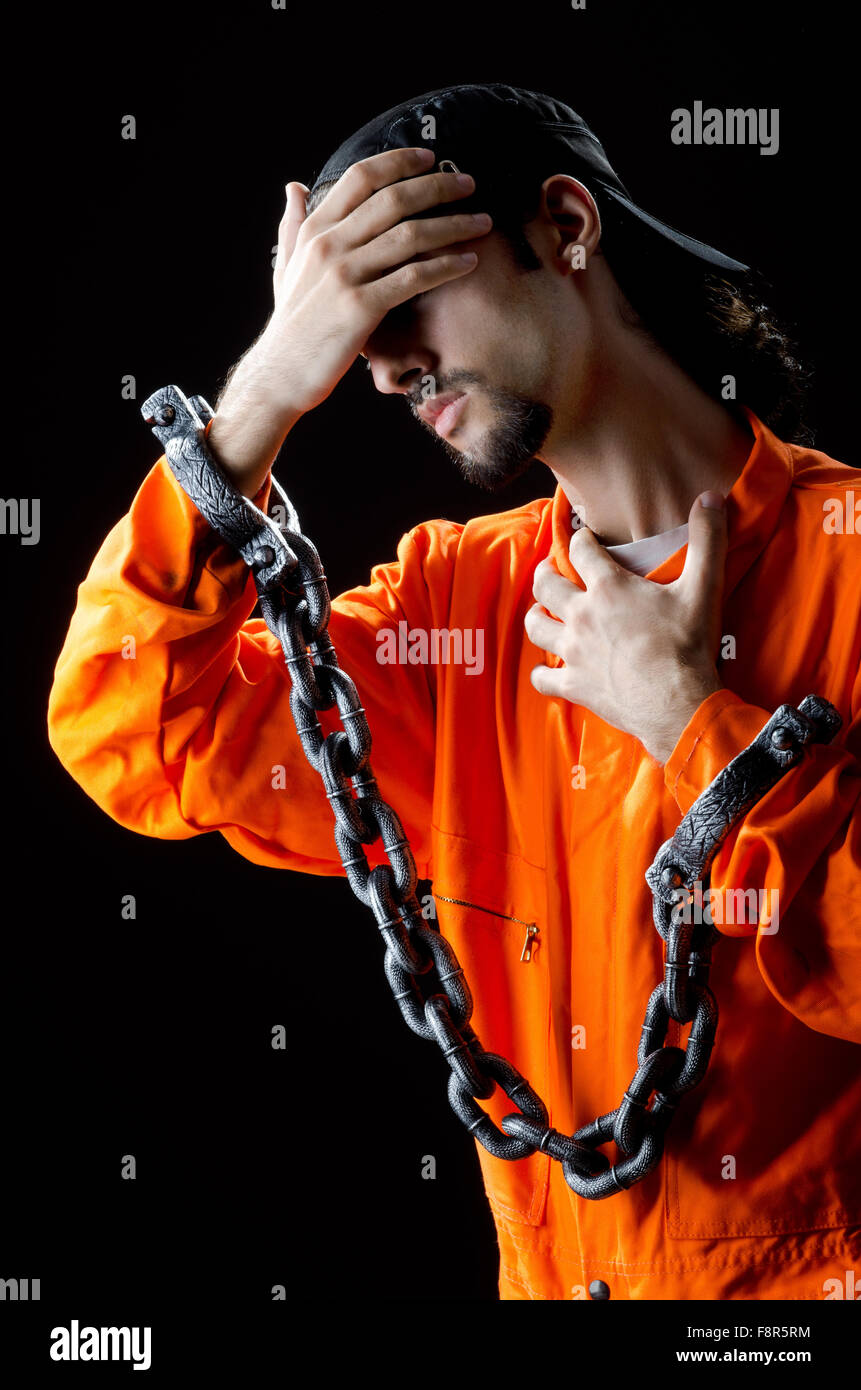 Inmate chained on black background Stock Photo - Alamy