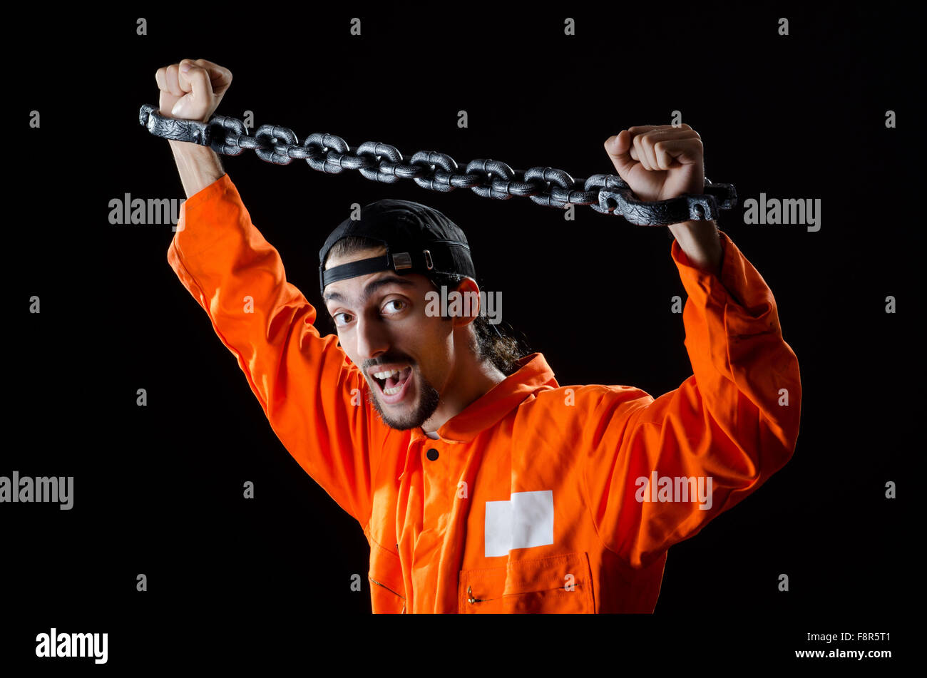Inmate chained on black background Stock Photo - Alamy