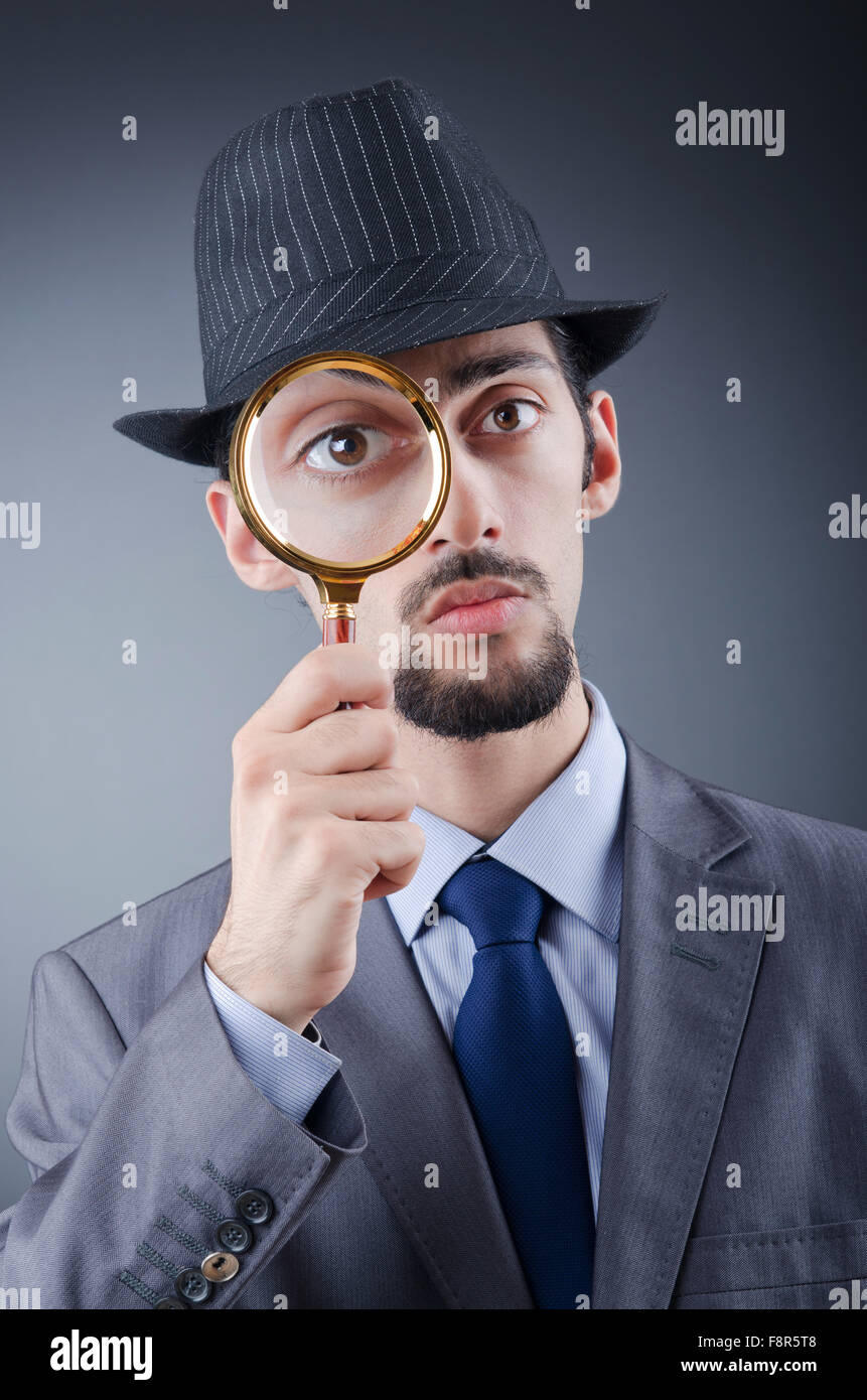 Detective and magnifying glass Stock Photo - Alamy