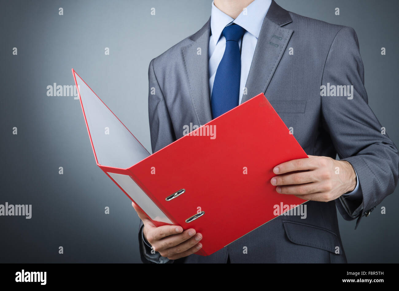 Young businessman with folders Stock Photo - Alamy