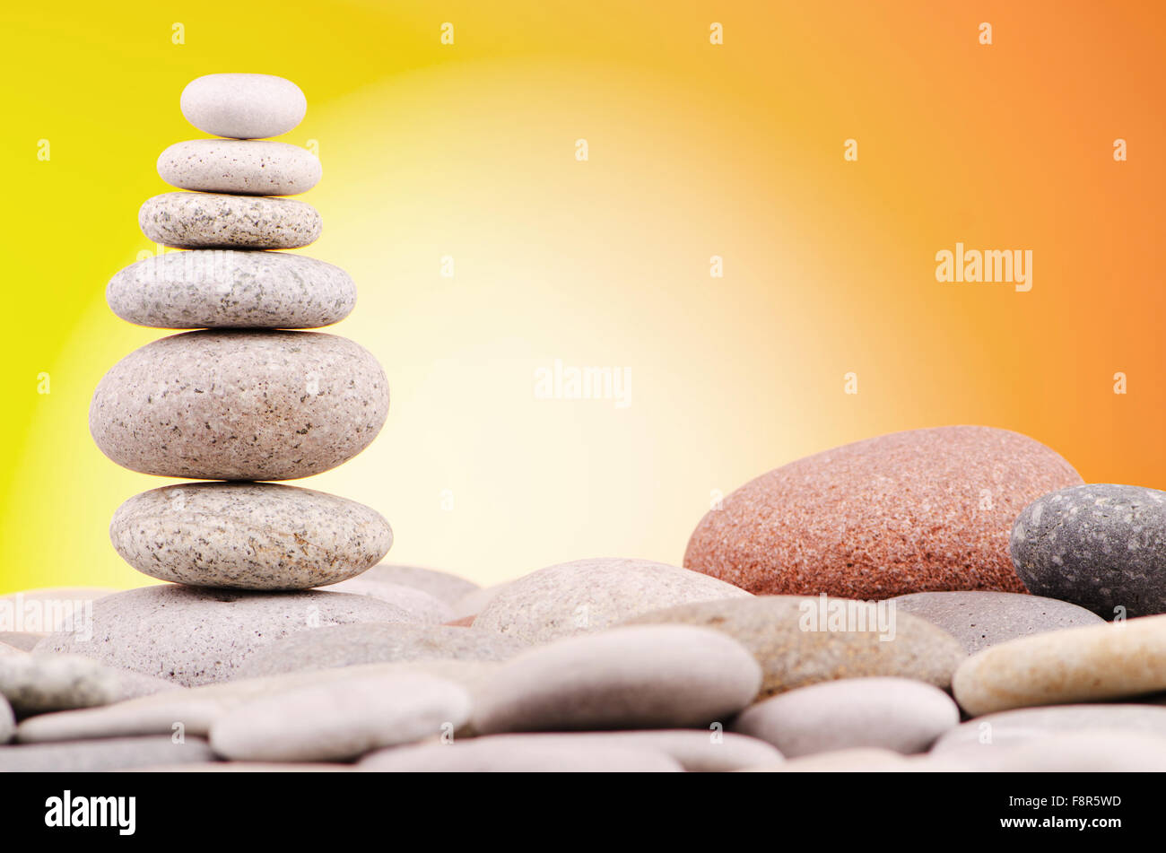 Pebbles stack against gradient background Stock Photo - Alamy