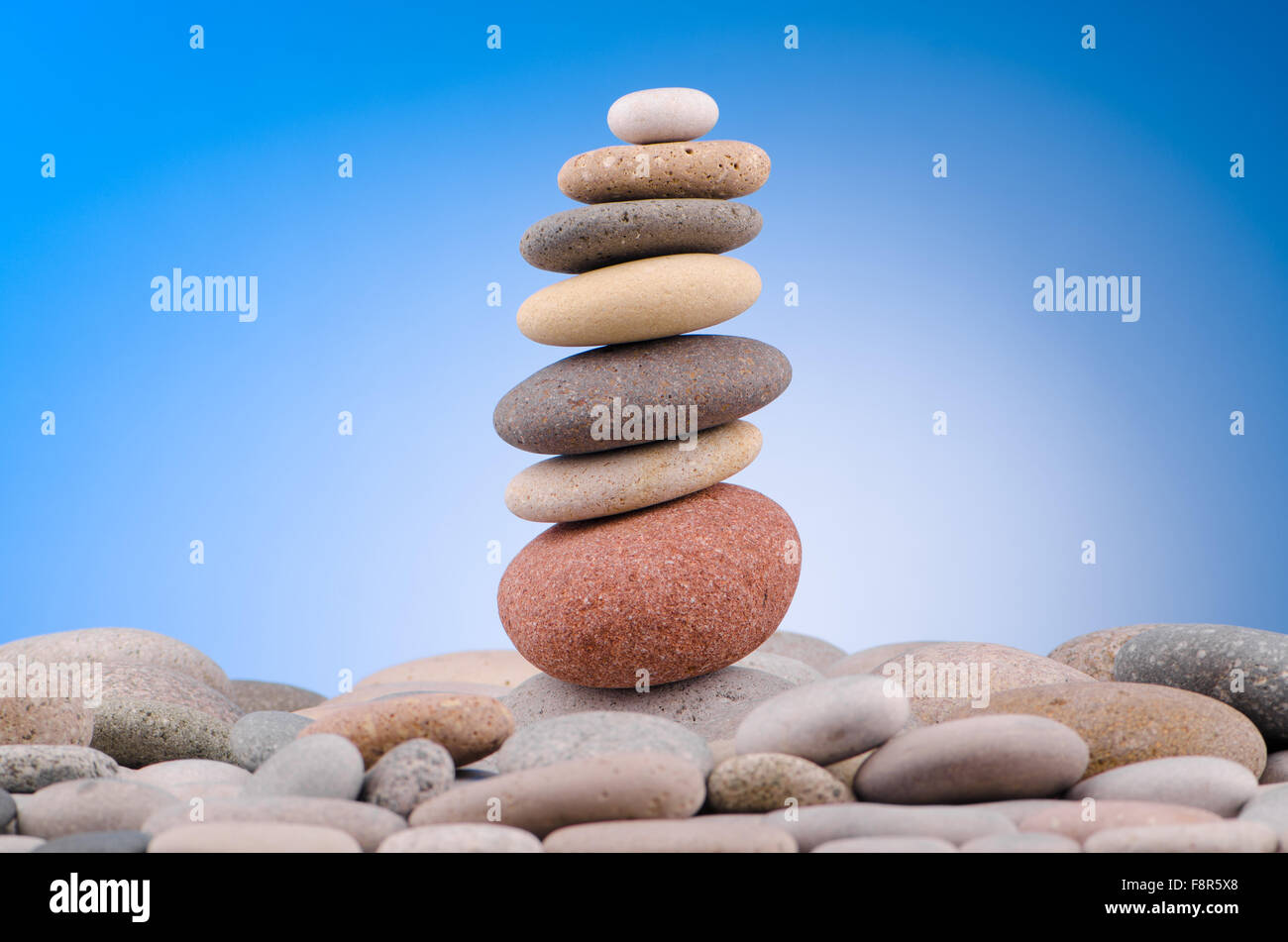 Pebbles stack against gradient background Stock Photo - Alamy