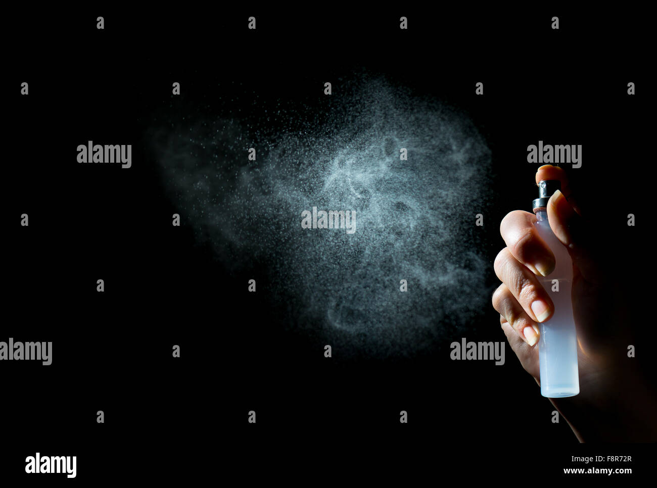 Blowing perfume in the form of small cloud particles Stock Photo - Alamy