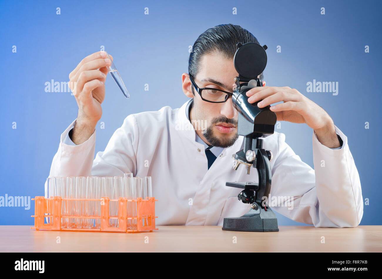 Chemist working with microscope Stock Photo - Alamy