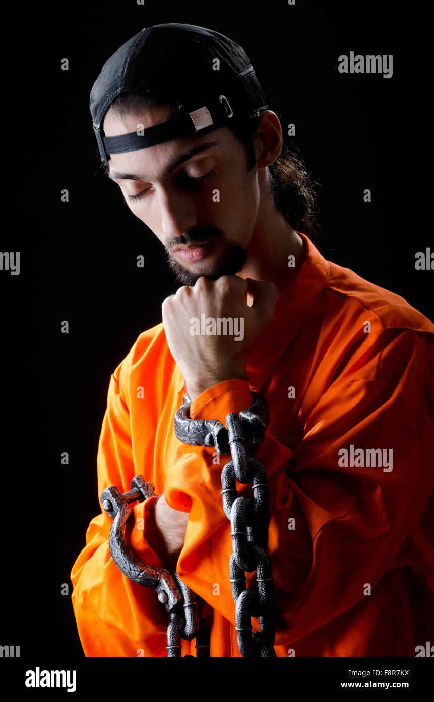 Inmate chained on black background Stock Photo - Alamy