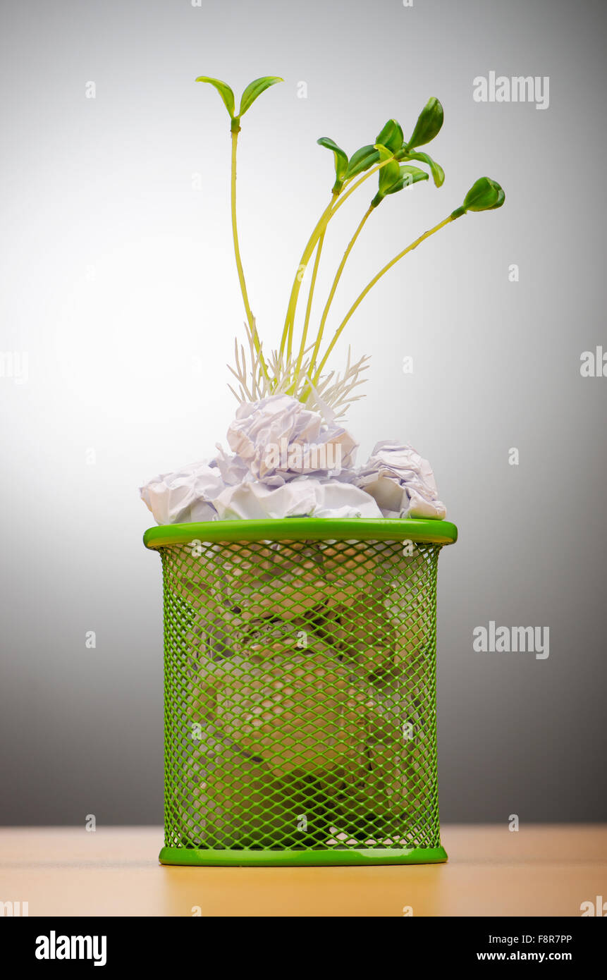 Green seedlings growing out of paper Stock Photo - Alamy