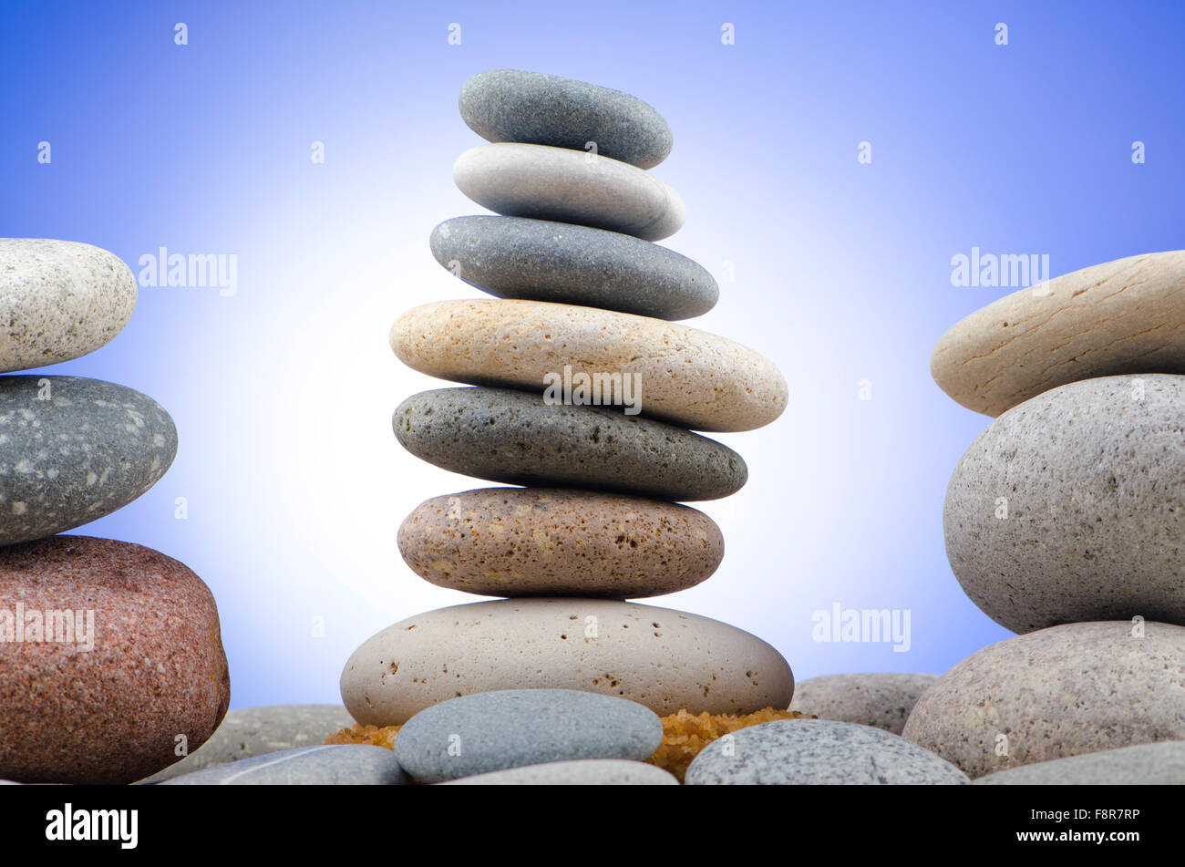 Balanced pebbles with colour background Stock Photo - Alamy