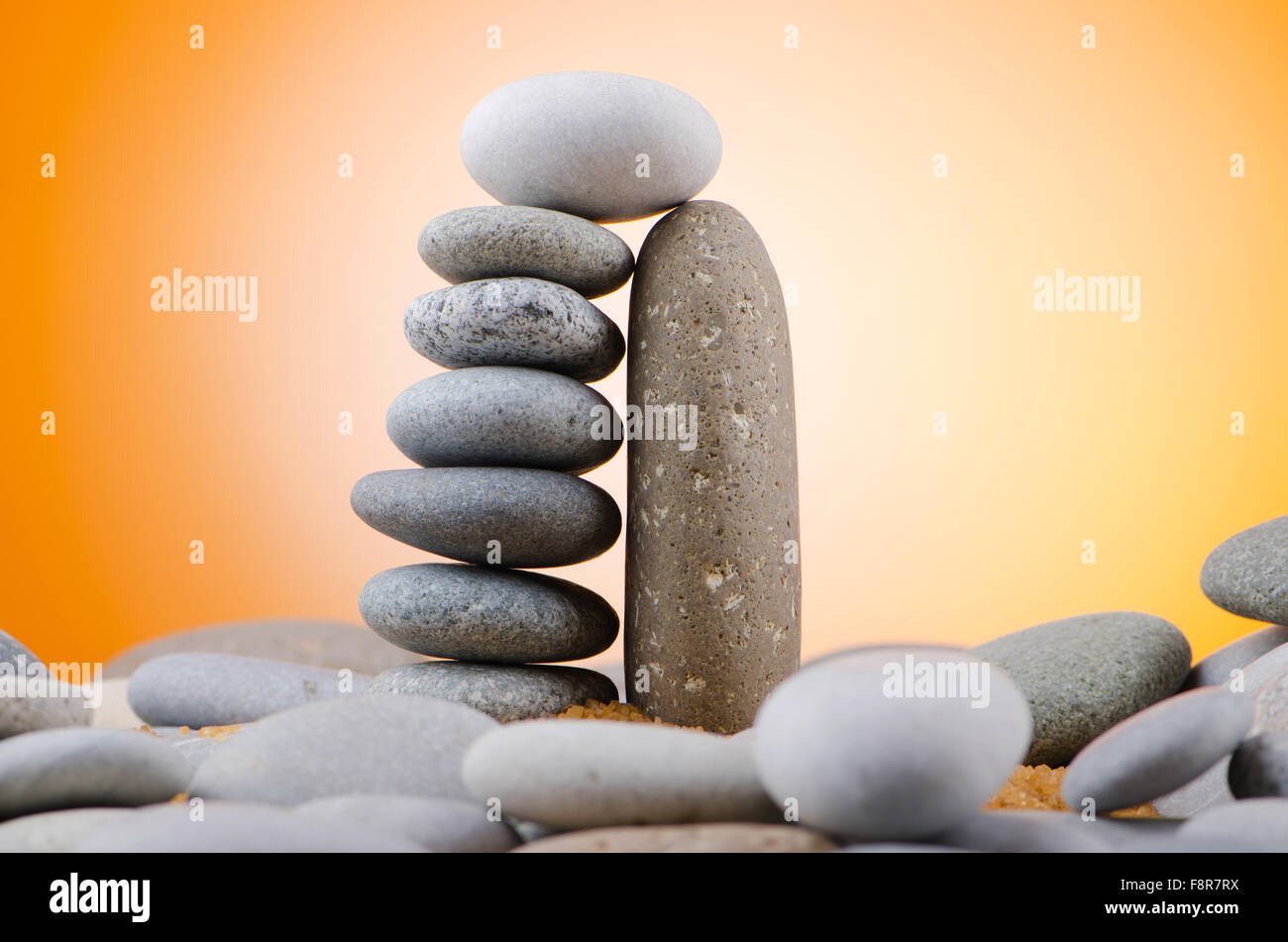 Balanced pebbles with colour background Stock Photo - Alamy